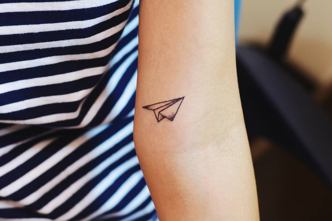 Paper airplane tattoo: learn the meaning and find some beautiful ideas